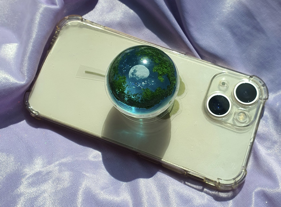 GripTok, the moon in the forest in the night sky