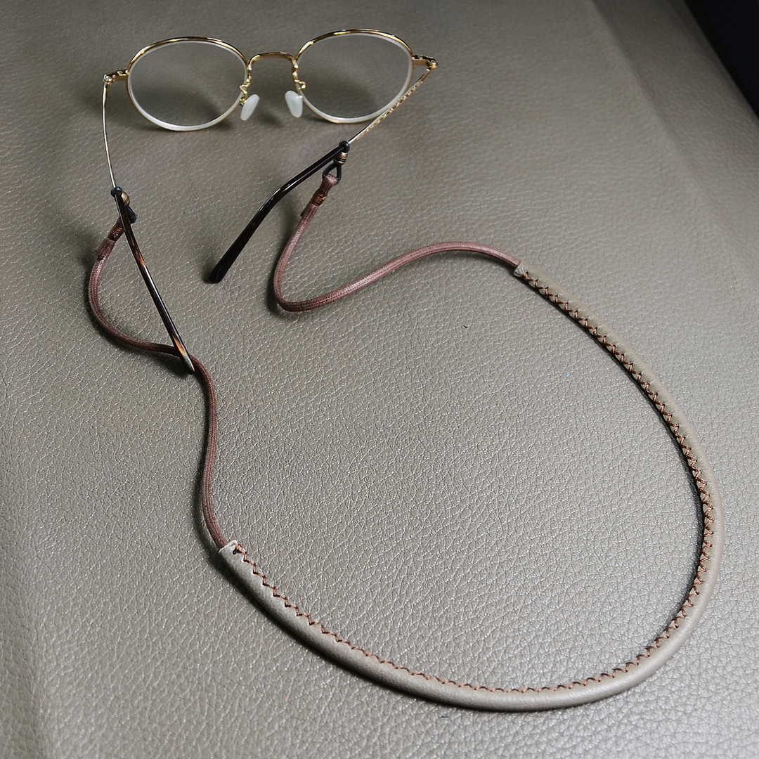 a string of glasses wrapped in handmade etof leather | idus